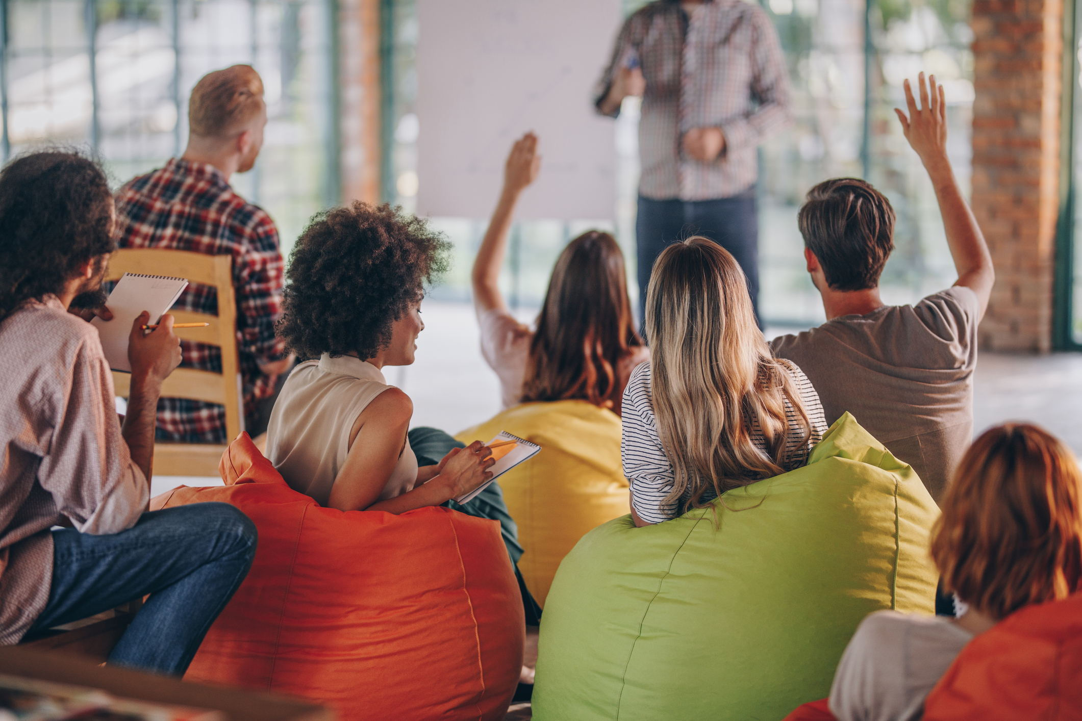 Back view of large group of freelancers on educational seminar. | Connected Families